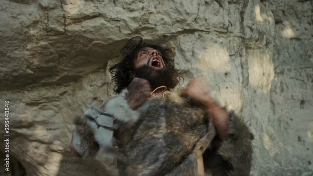 Portrait of Primeval Caveman Wearing Animal Skin Does Aggressive Chest ...