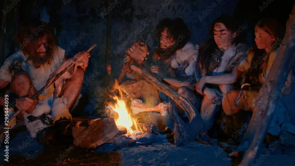 Neanderthal or Homo Sapiens Family Cooking Animal Meat over Bonfire and ...