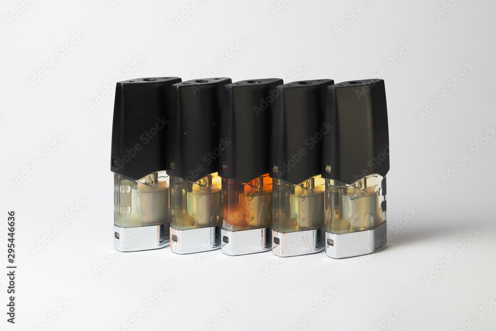 e-juice vape refill pods with liquids of different shades of orange ...