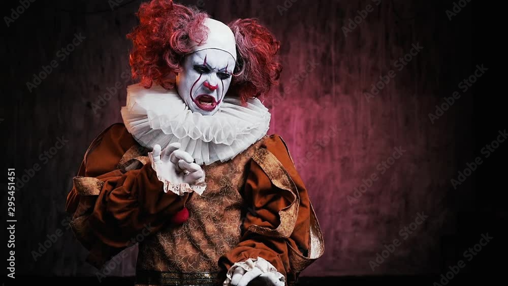 Sinister clown with colorful makeup depicts disgust. Frightening clown ...