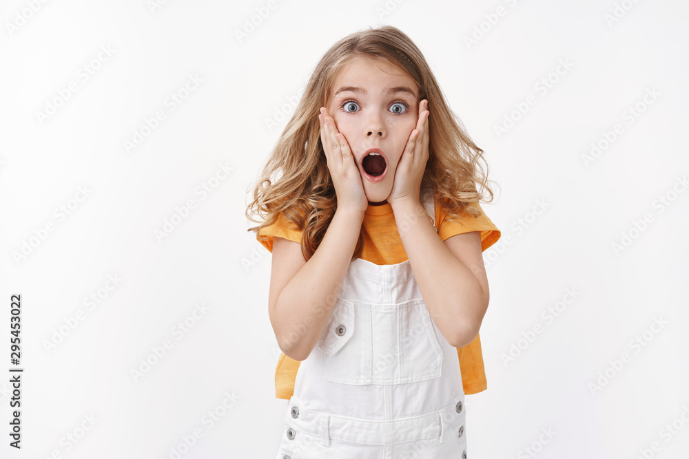 Scared and shocked caucasian blond little girl gasping, grab face ...
