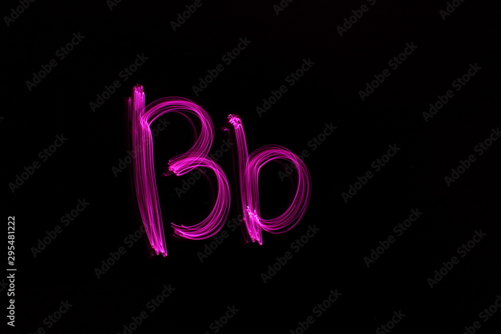 Long exposure photograph of the letter b in pink neon color, in upper ...