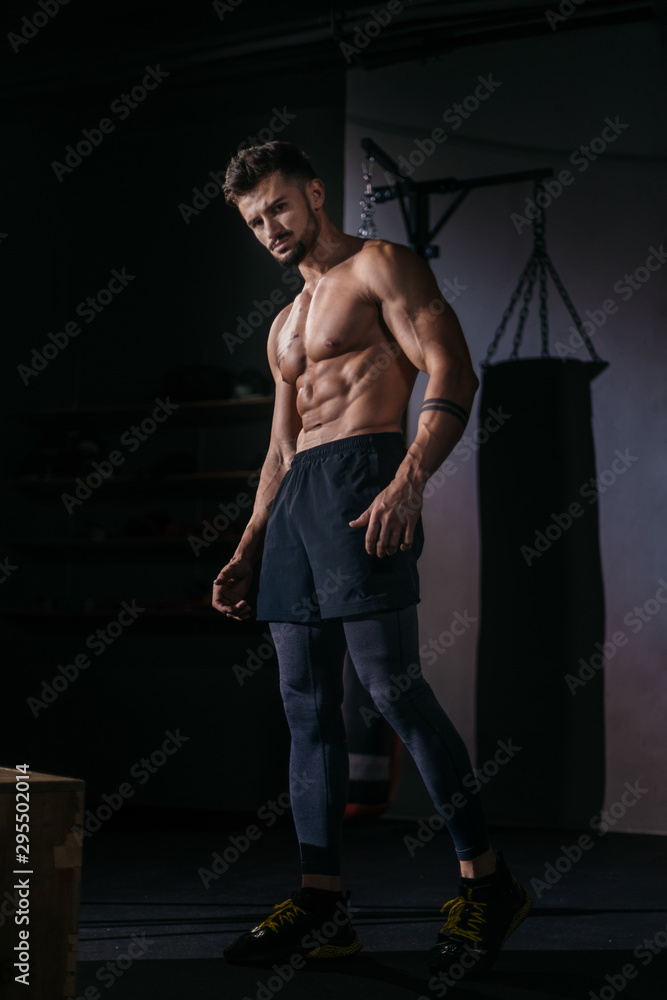 Professional bodybuilding man posing in front of the camera showing his ...