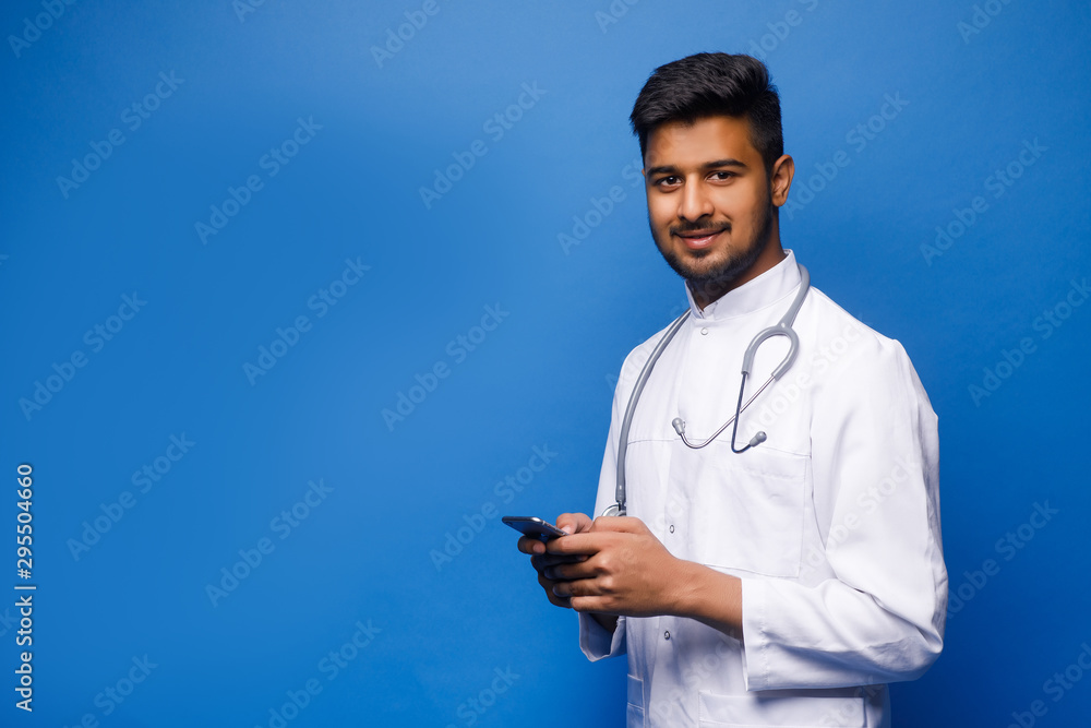 Happy looking Indian male doctor using/speaking over or presenting ...