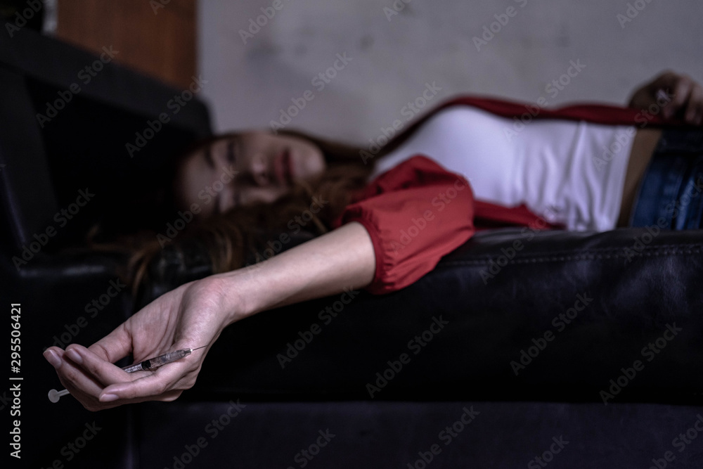 Drugged woman lying with a syringe, Drug overdose and the shocked ...