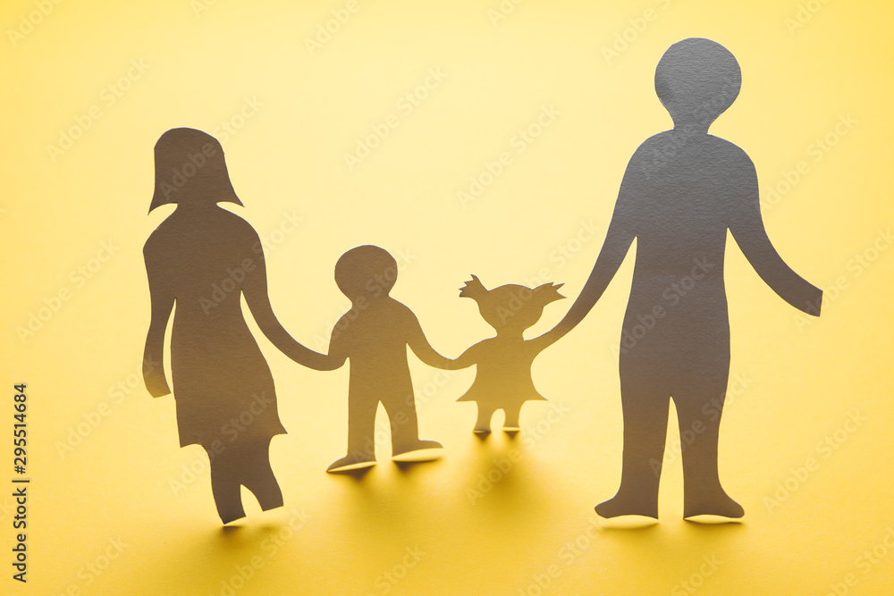 Family paper chain cutout holding hands on the yellow background Stock ...