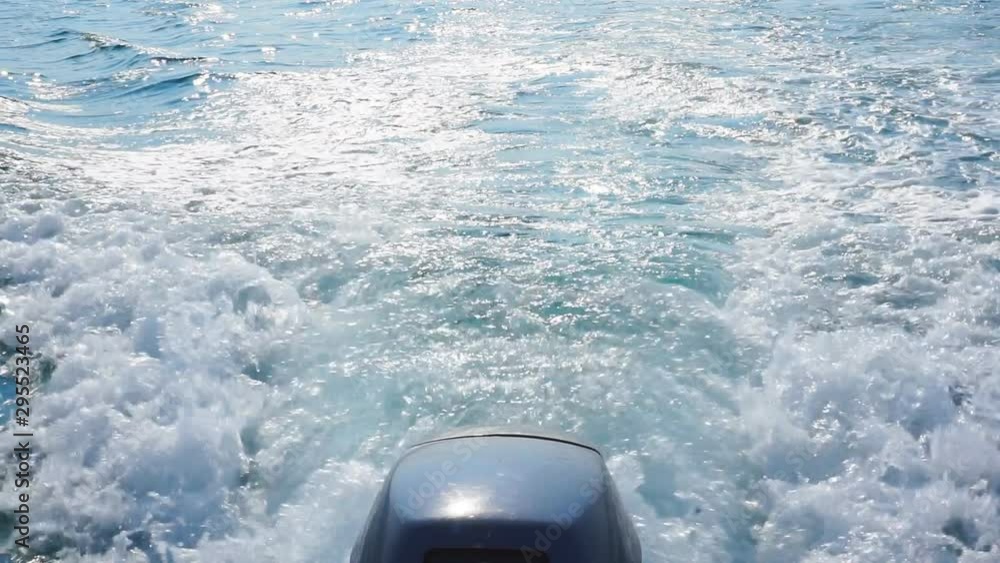 Outboard motor creates waves on the surface of the ocean. Trace of ...