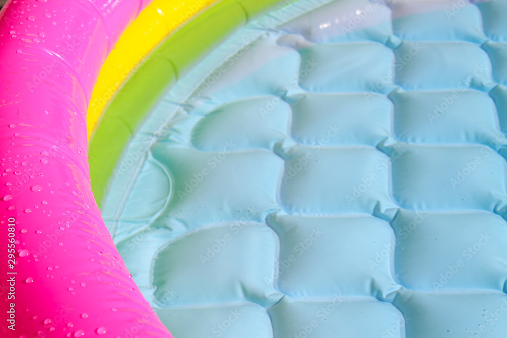 Bright blue inflatable paddling pool surface with water ripples. Summer ...