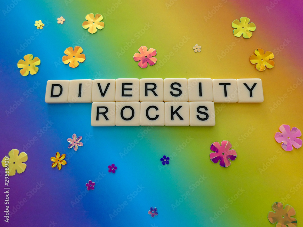 Bright rainbow colored background sign with the words "DIVERSITY ROCKS ...