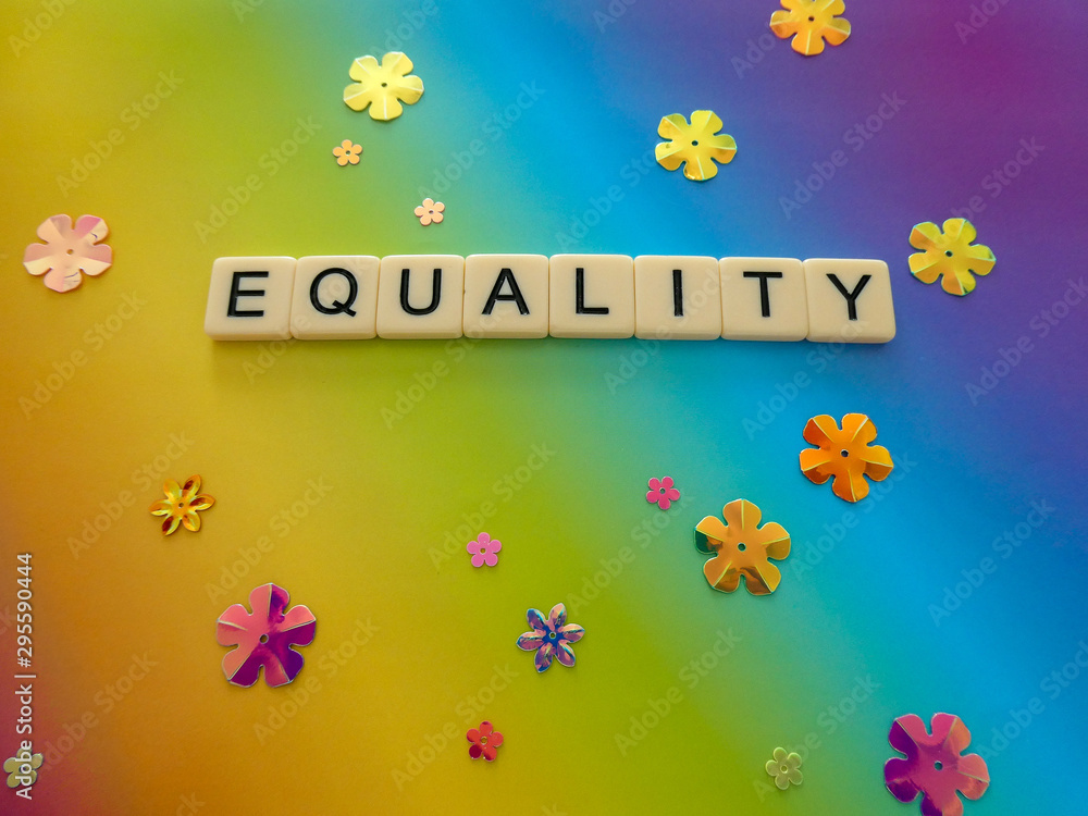 Bright rainbow colored background sign with the word "EQUALITY" in text ...