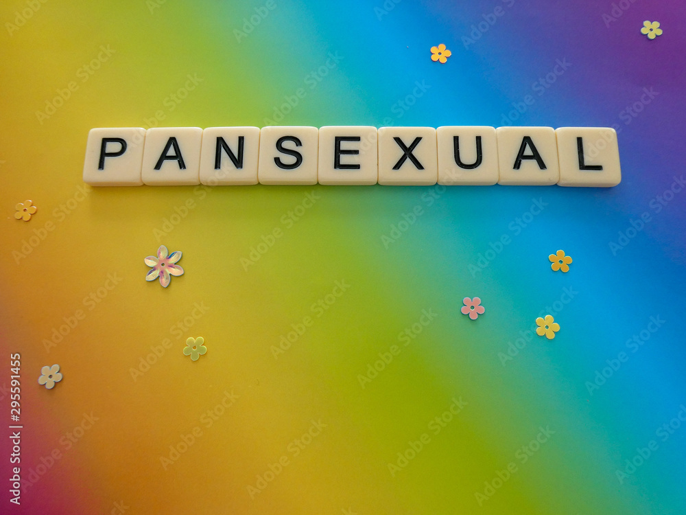 Bright rainbow colored background sign with the word "PANSEXUAL" in ...