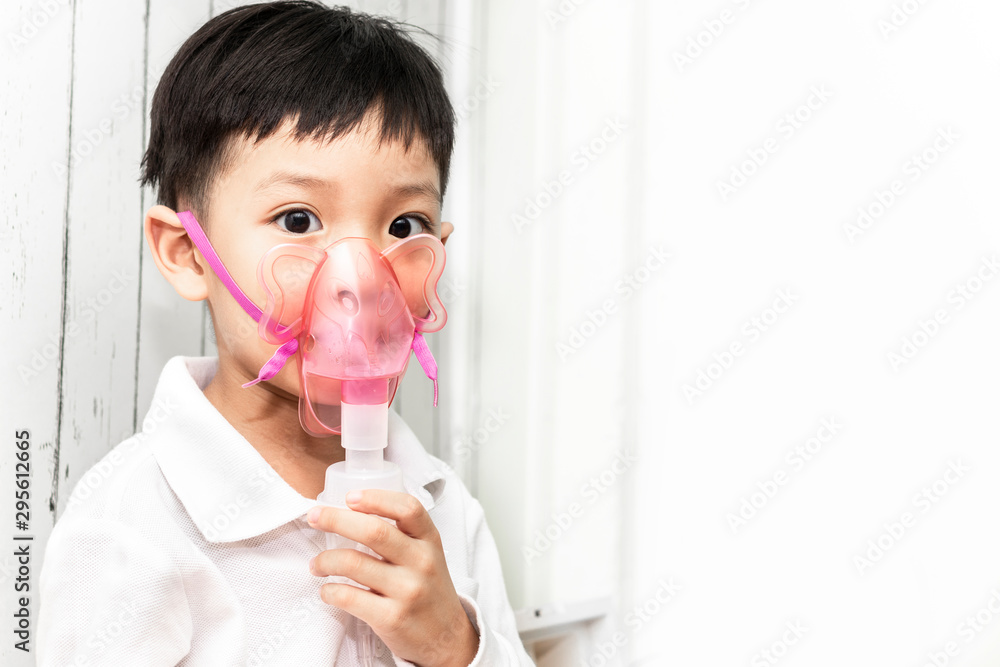 Asia boy using nebulizer and inhaler for the treatment. Little child ...