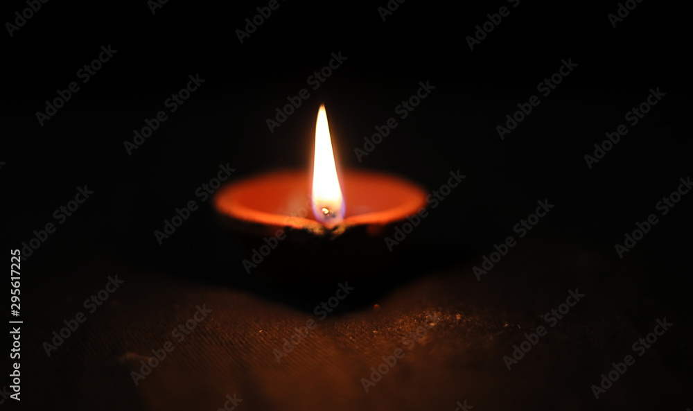 Diya lamp with fire. Traditional Divali festival. Close up Stock Photo ...