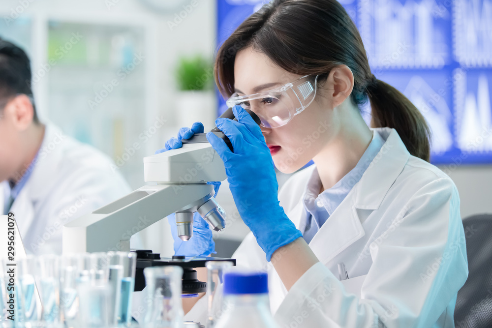 Asian scientist use microscope Stock Photo | Adobe Stock