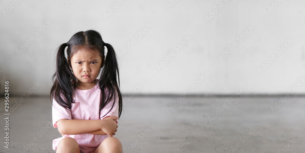 Asian child cute touchy or kid girl sitting face frown and angry ...