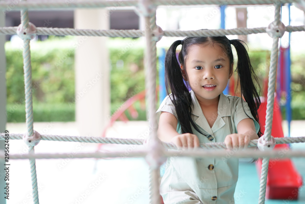 Asian child cute or kid girl smiling playing rope climbing and happy ...