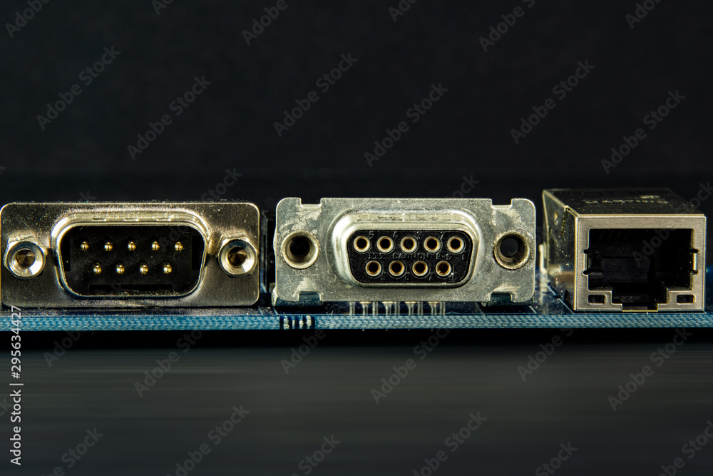 Serial type d connector and ethernet RJ45 sockets on a board with black ...