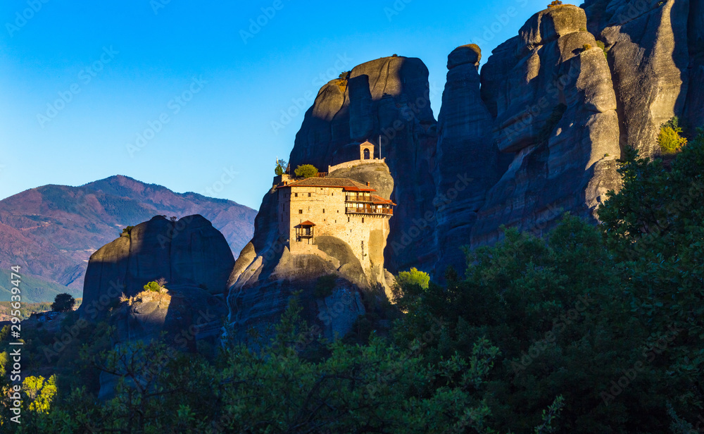 Greece. Meteors. The building on the rock is illuminated by the sun ...