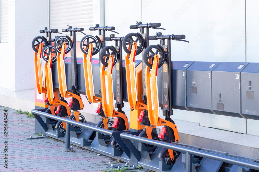 Electric Kick scooter in sharing parking lot. Scooter rental station ...