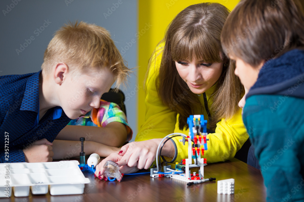 Positive children play and assemble the constructor in the children's ...
