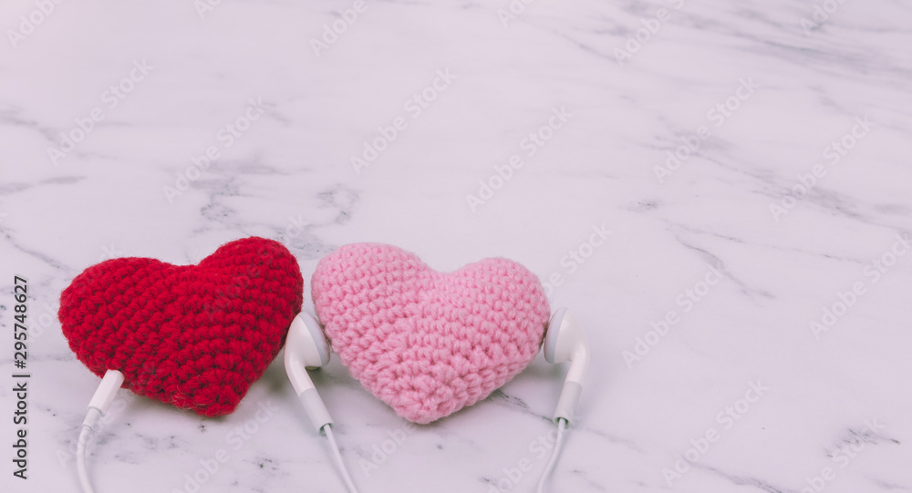 Lovely pink heart use headphone to listen love song or music from happy ...