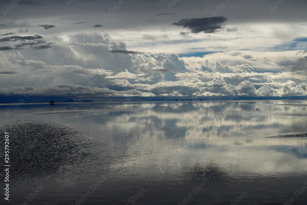 The Salar de Uyuni flooded after the rains, Bolivia. Clouds reflected ...