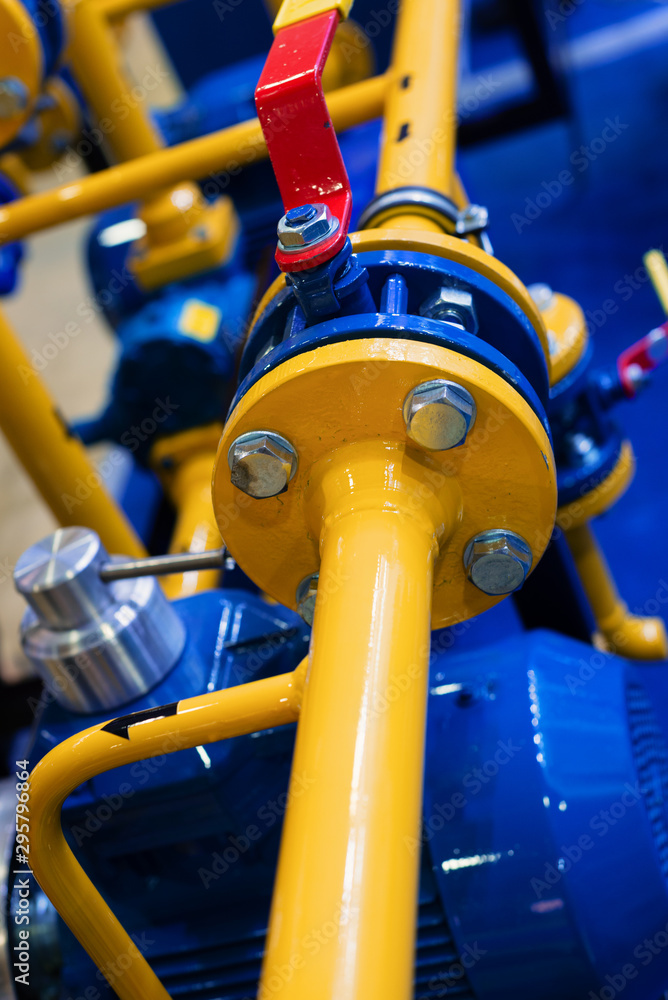 Gas station. Many diverse pipes connected by flanges. Flange bolt ...