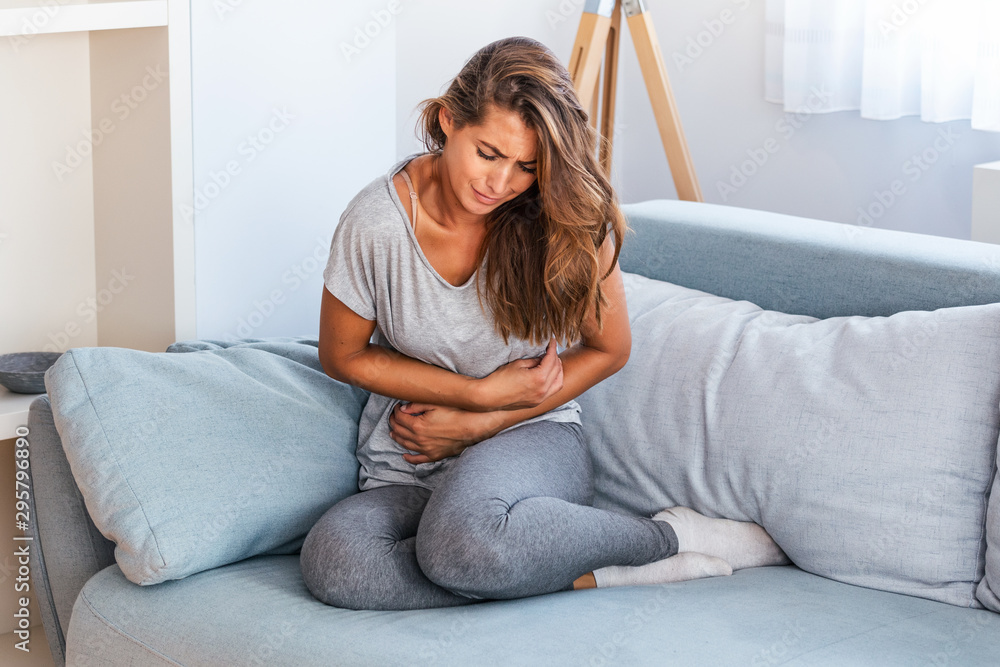 Woman suffering from backache at home. Lower Back Pain . Woman feels ...