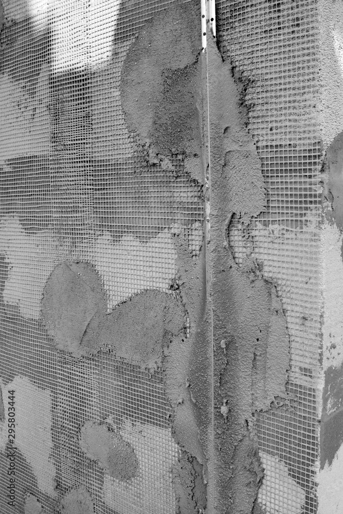 surface of wall with applied construction grid and guides for plaster ...