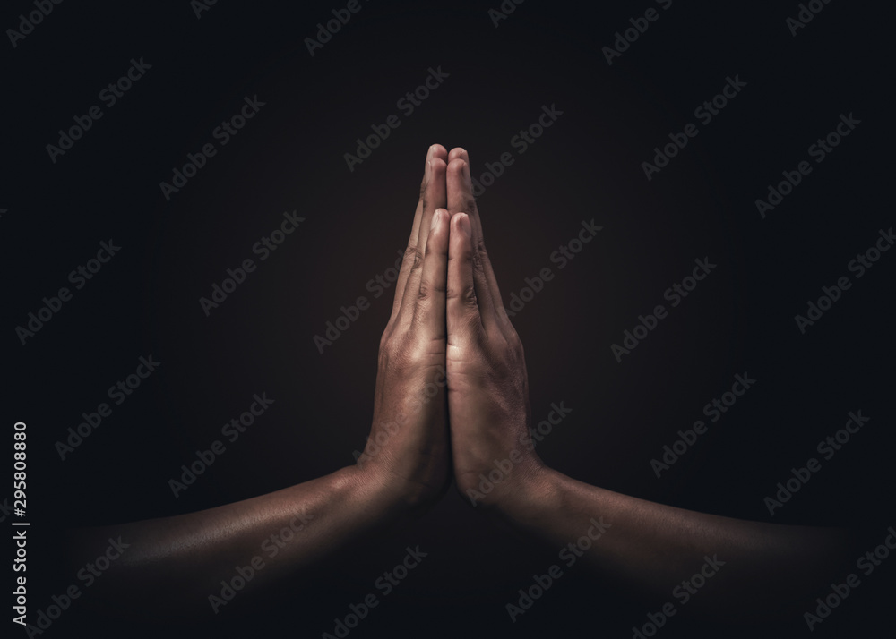 Praying hands with faith in religion and belief in God on dark ...