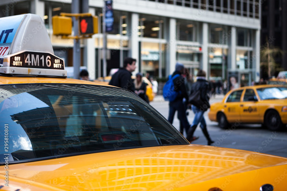 NYC taxi on the streets of New York. A candid street scene viewed over ...