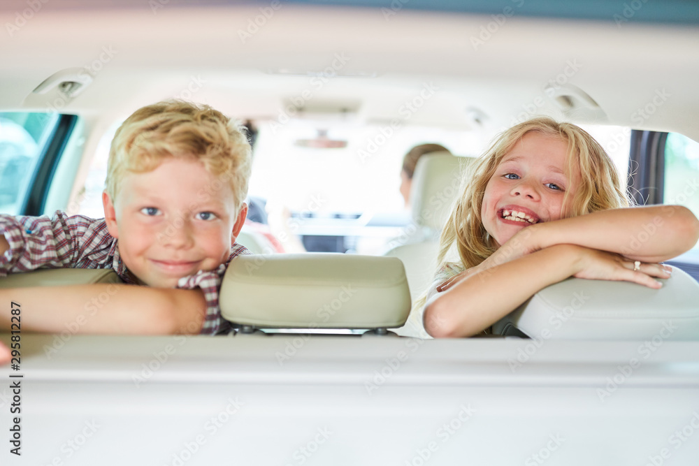Two kids in the back seat in the car Stock Photo | Adobe Stock