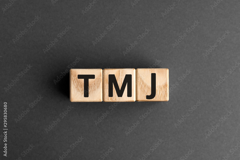 TMJ - acronym from wooden blocks with letters, abbreviation TMJ ...