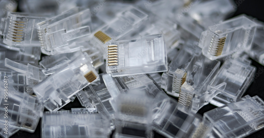 Pile of transparent RJ45 connectors and their components, ready for ...