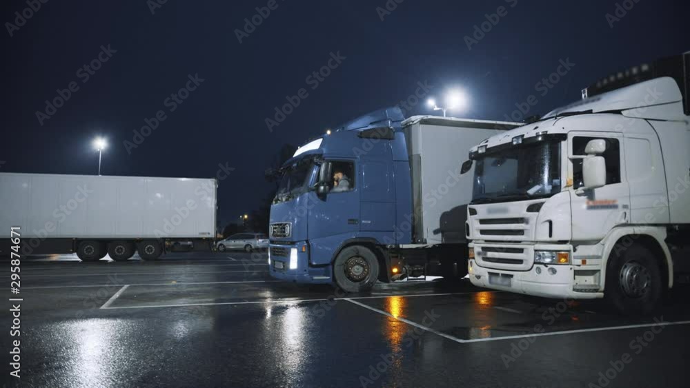 Blue Semi-Truck with Cargo Trailer Drives Into Overnight Parking Space ...