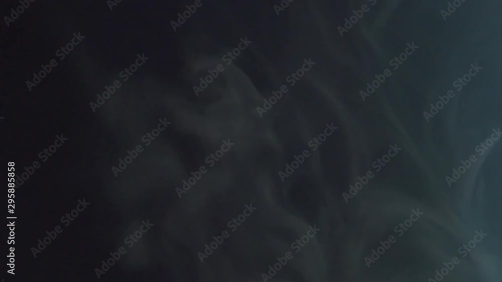 Smoking machine blowing smoke into the picture from above before black ...