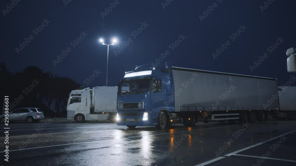 Blue Semi-Truck with Cargo Trailer Drives Into Overnight Parking Space ...