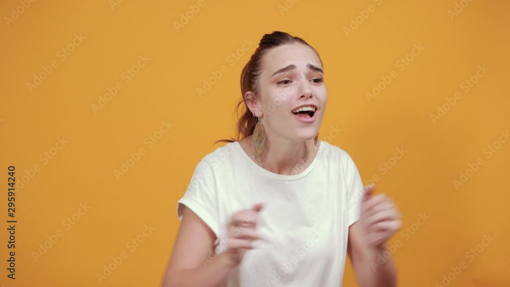 Beautiful young Caucasian girl wearing a nice white T shirt cheering ...