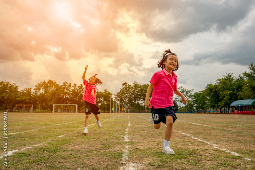Kids running and playing on field racing in sport day of school, happy ...