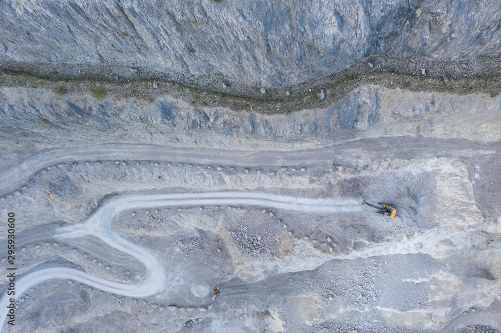 bird's eye view to stone pit quarry with shovel excavator tracks and ...