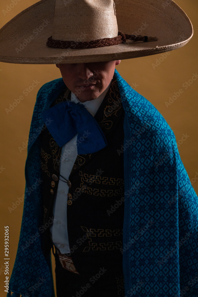 Charro young Mexican portrait with blue sarape posing with sombrero ...