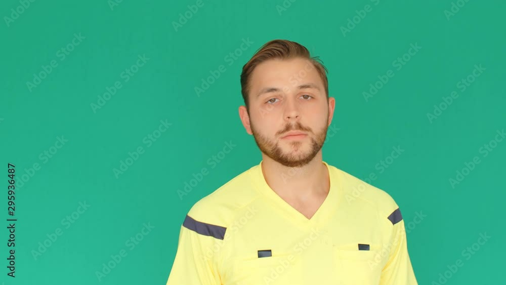 Football Soccer referee on green screen showing VAR Video Assistant ...