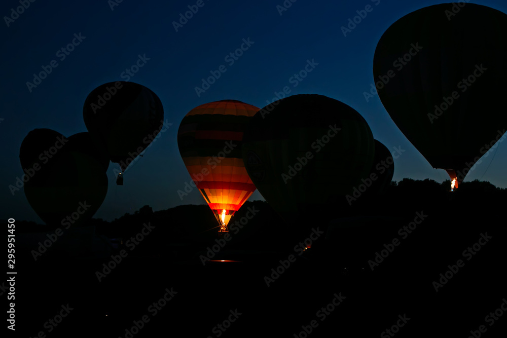 People in basket of hot air balloon in the background of sunset. Burner ...