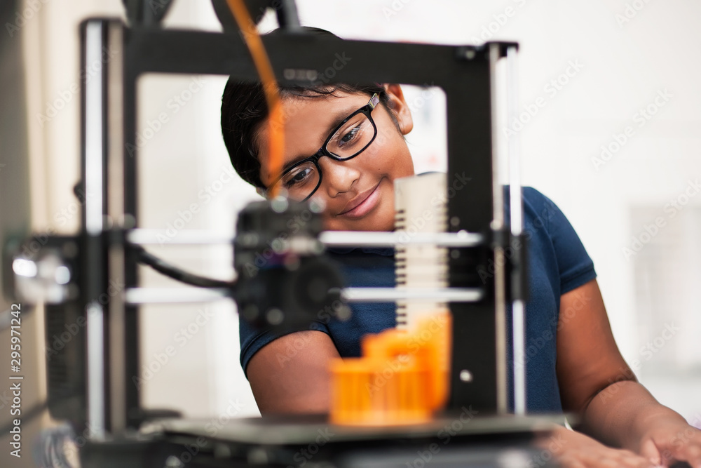 A smart little girl admiring her 3D printed model from behind the 3D ...