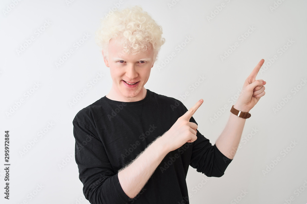 Young albino blond man wearing black t-shirt standing over isolated ...