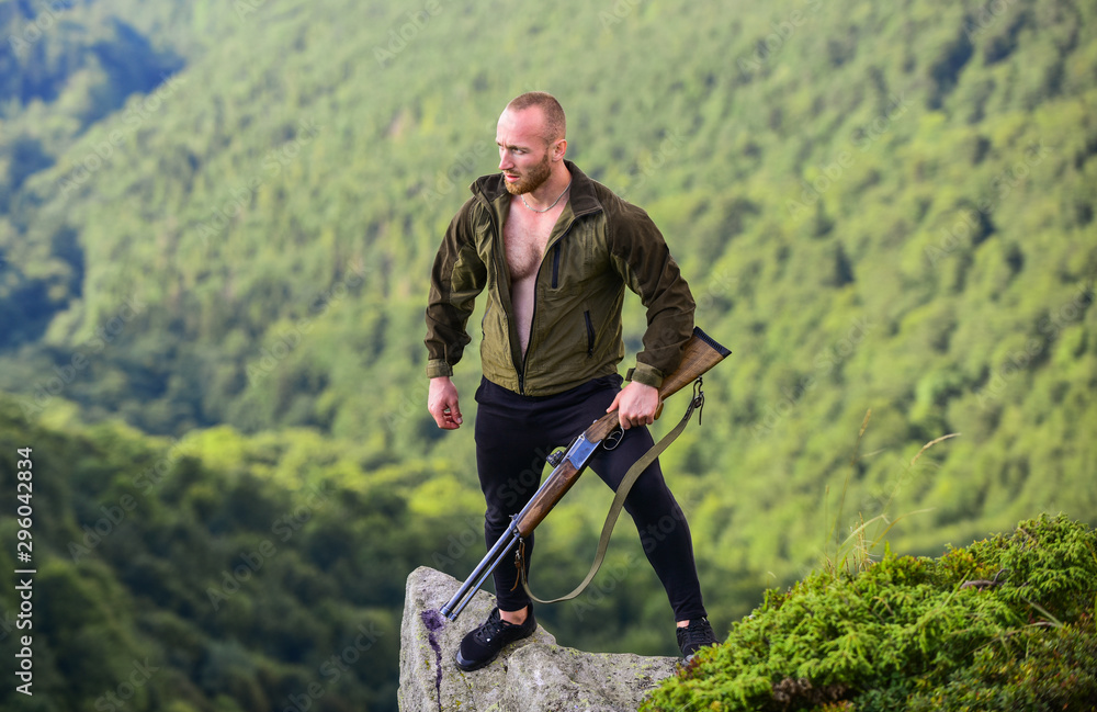 Poacher stand on edge of cliff. Poaching concept. Man brutal poacher ...