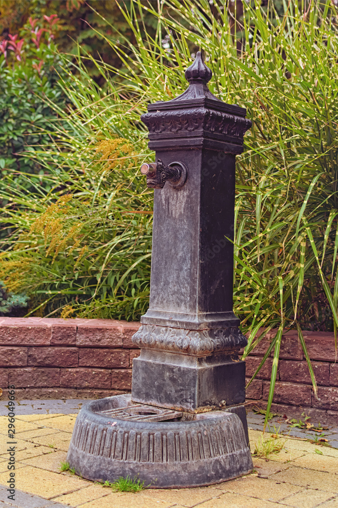 Ancient black column for distribution of drinking water installed in ...