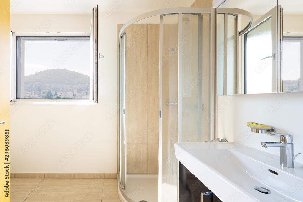 Front view with sink with shower and open window on the Swiss hills ...