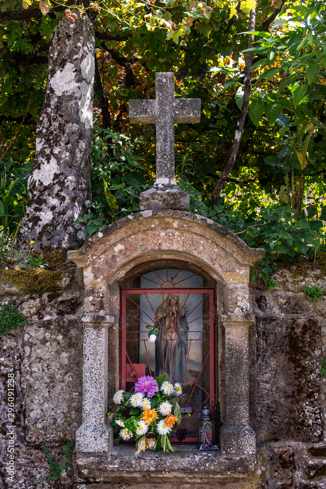 Antique a traditional small stone oratory with a granite cross and a ...