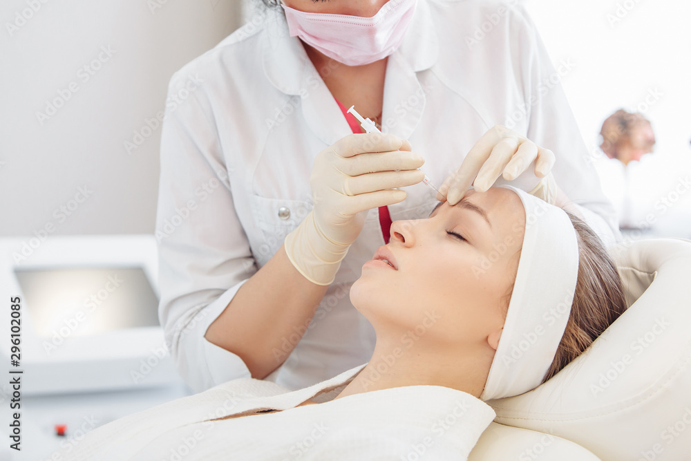 Unidentified master cosmetologist makes botox injections into the ...